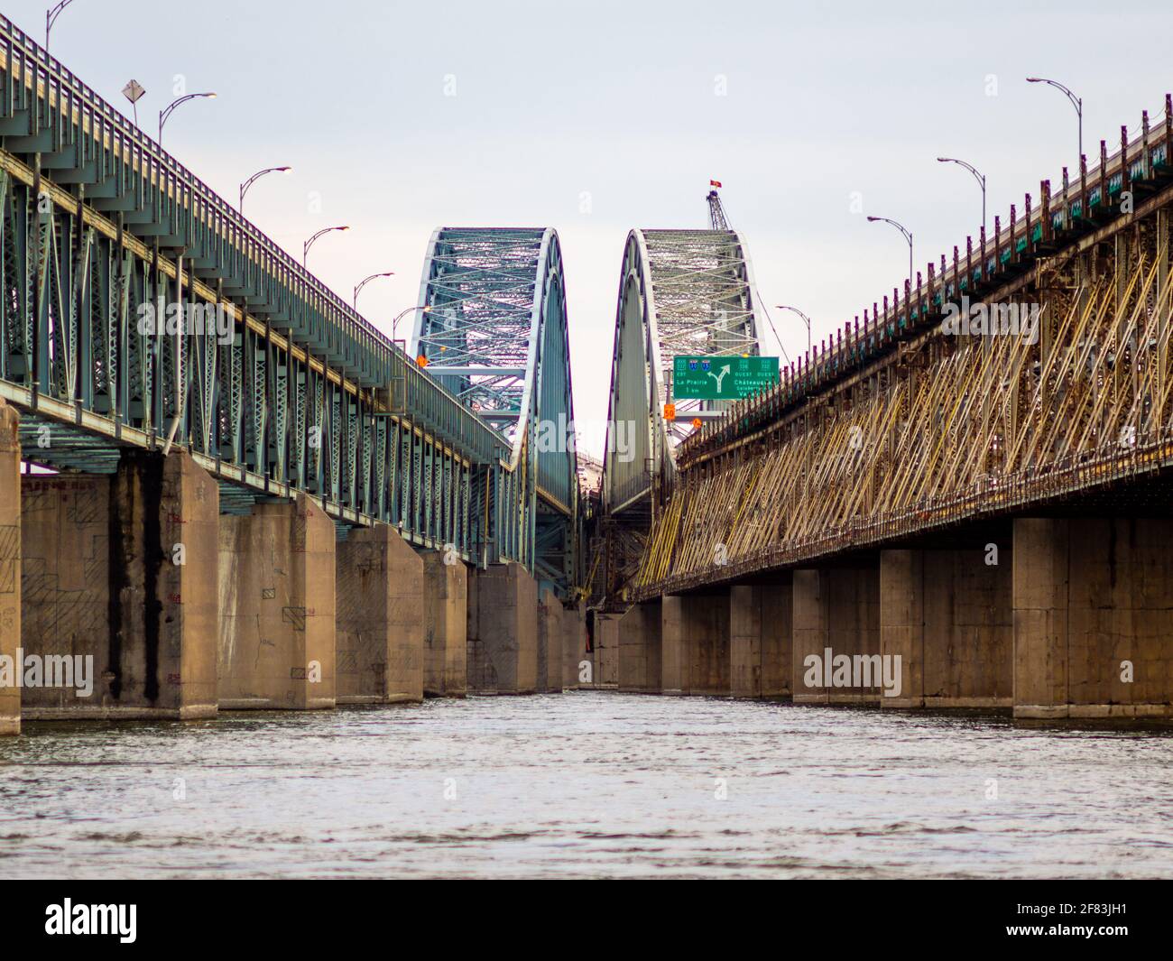Two metal suspension bridges view from between Stock Photo - Alamy