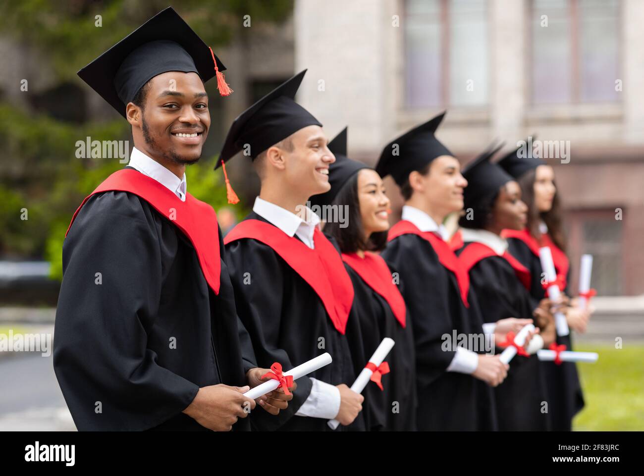 Diverse International Students With Diplomas Attending Graduation