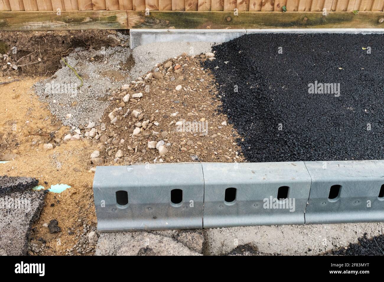 Unfinished paving during roadworks. Layers of tarmac, sand, and rubble ...