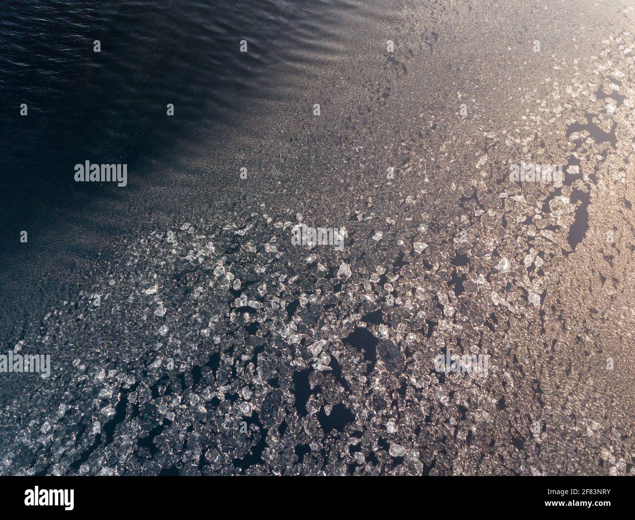 Pieces of ice and slush formed by wind at freezing lake water Stock ...