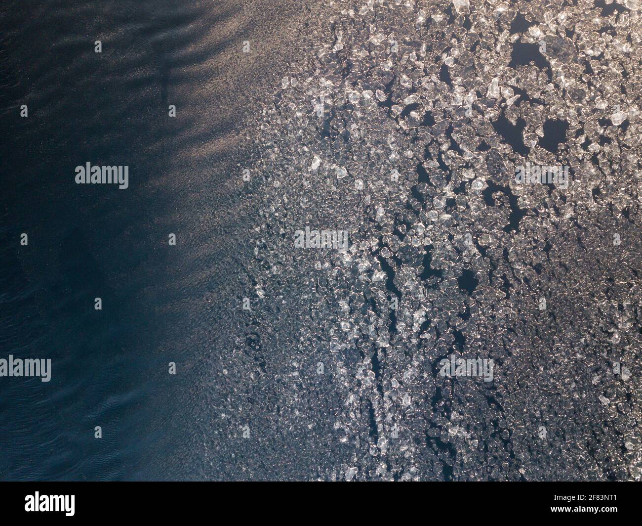 Pieces of ice and slush formed by wind at freezing lake water Stock ...