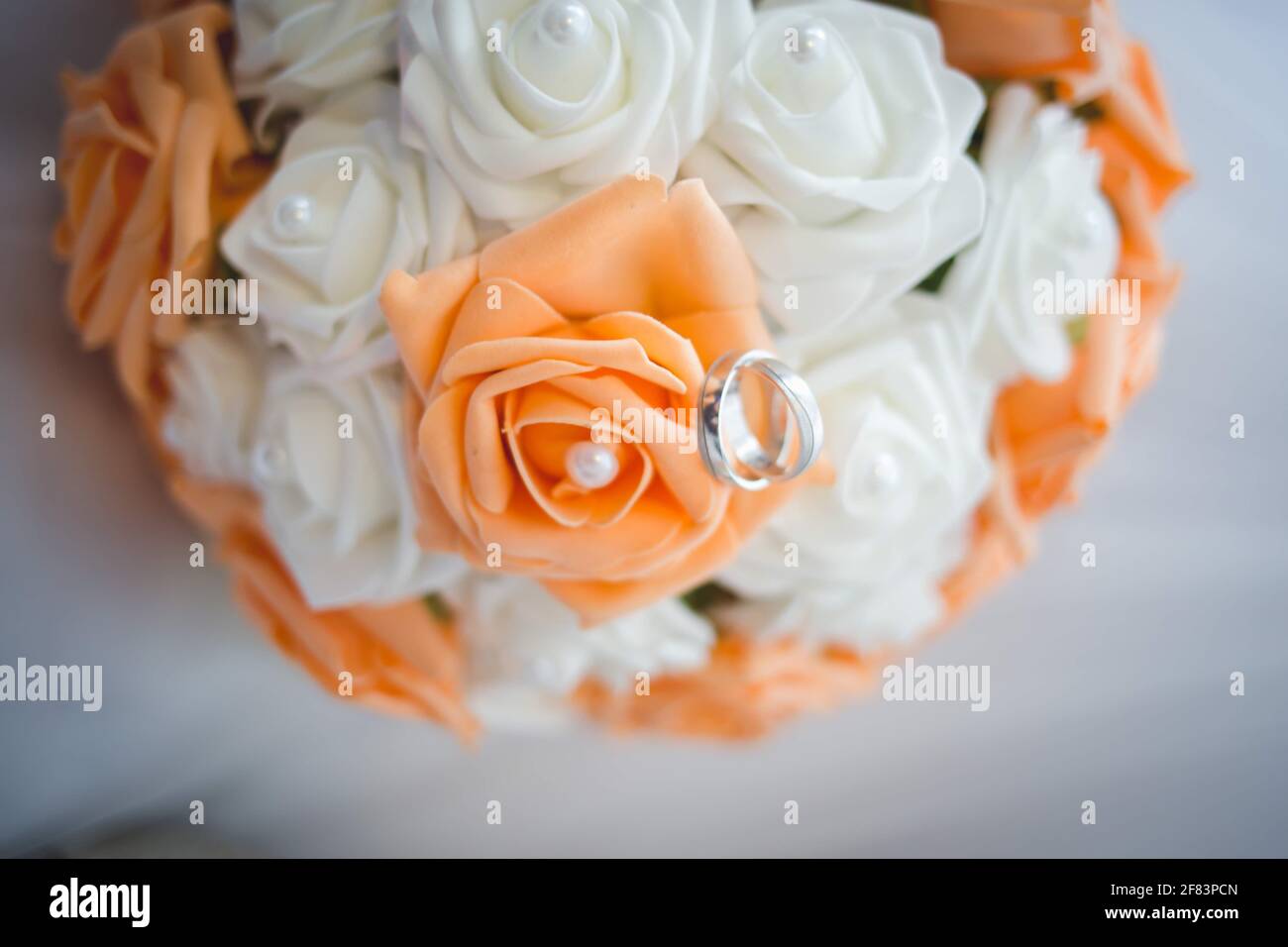 A closeup shot of two wedding rings put on a flower bouquet Stock Photo ...