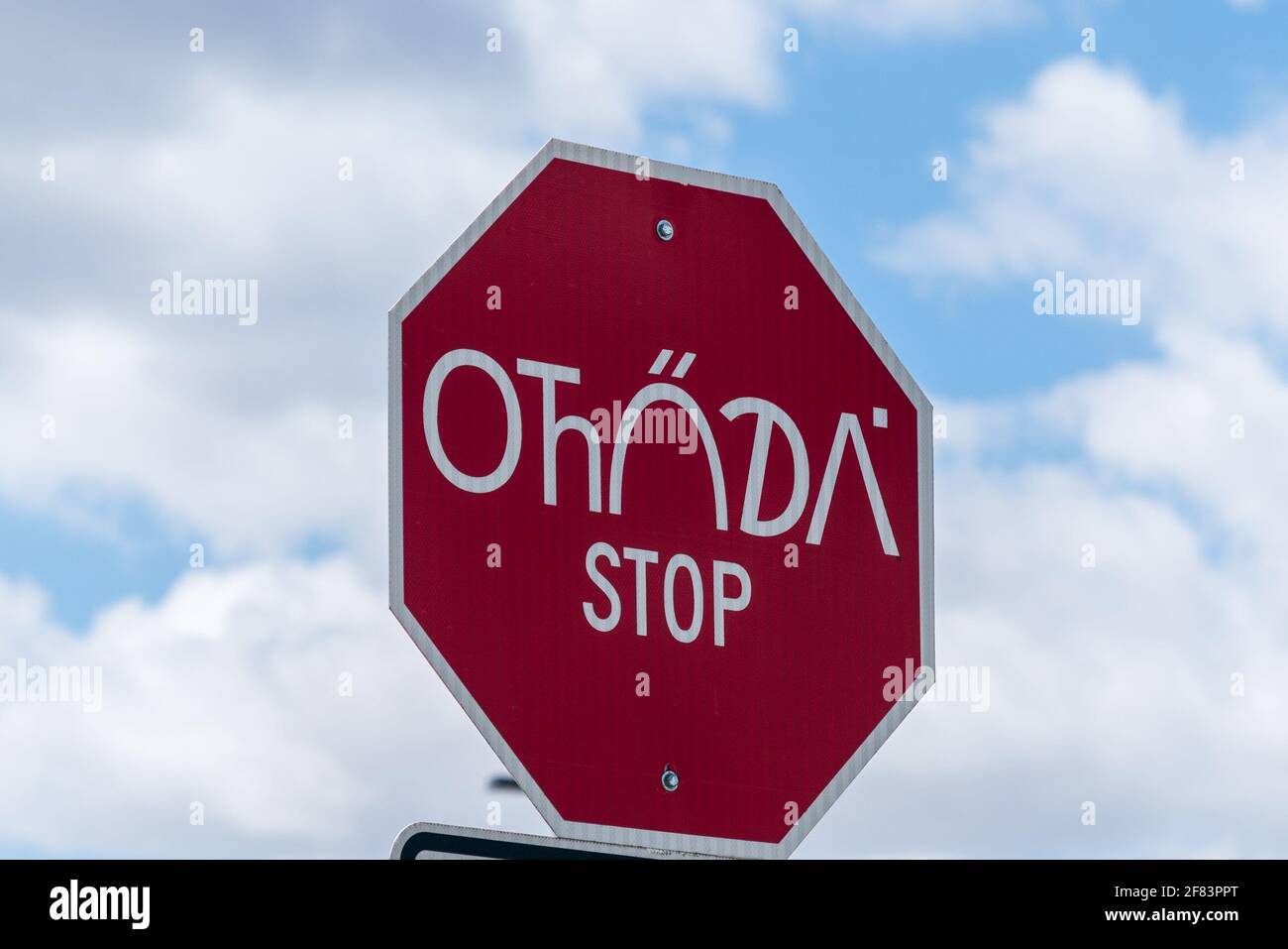 A stop sign in the Osage Nation written in traditional language Stock ...