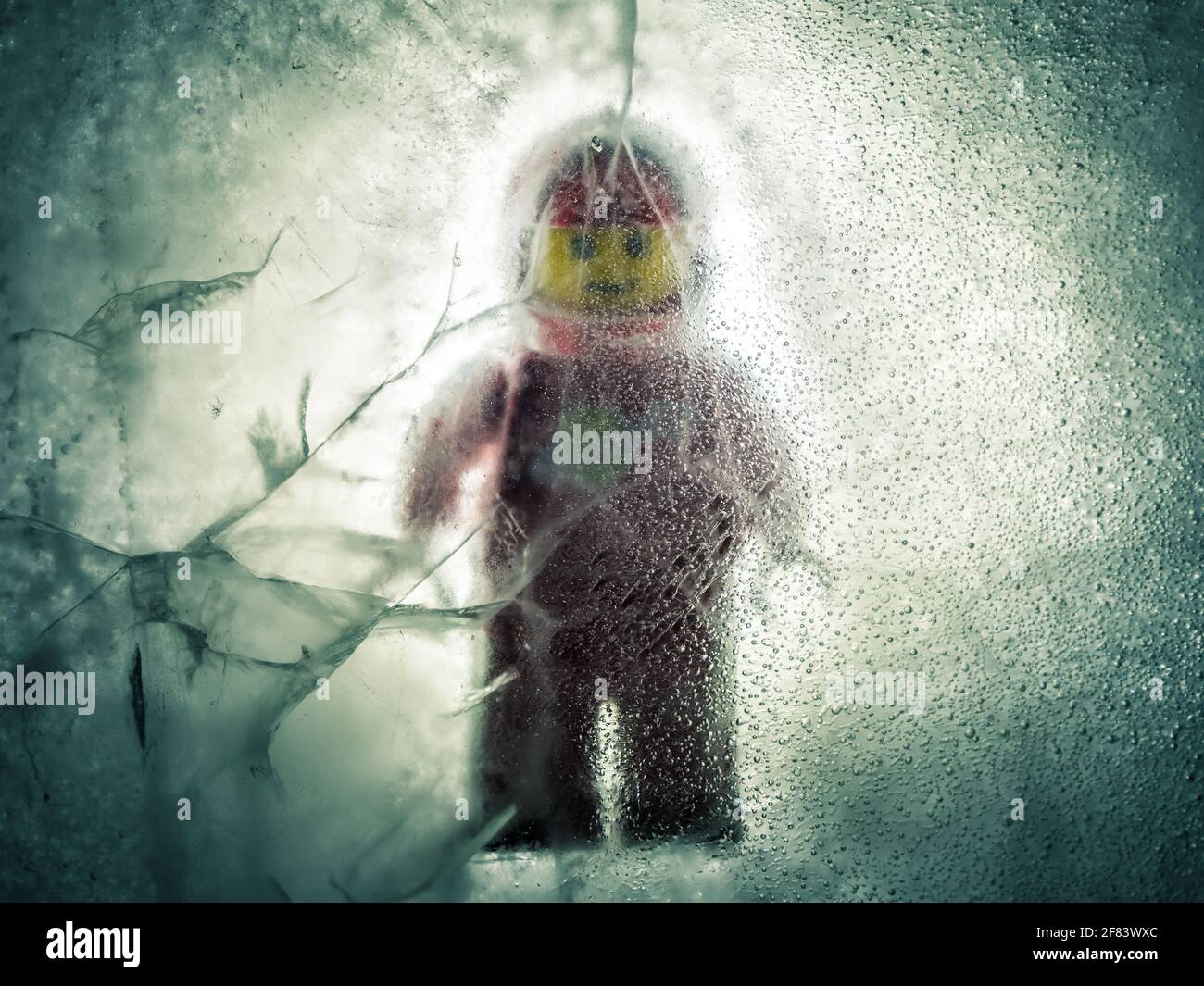 Astronaut minifigure frozen inside glowing ice Stock Photo - Alamy