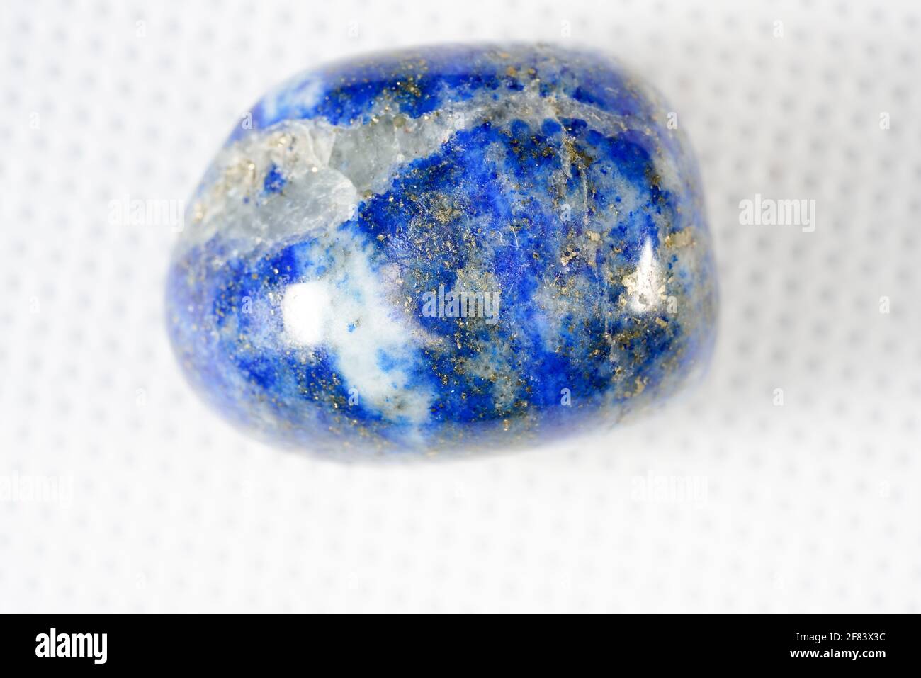 A closeup of Lapis lazuli Metamorphic Rock on a white background Stock ...