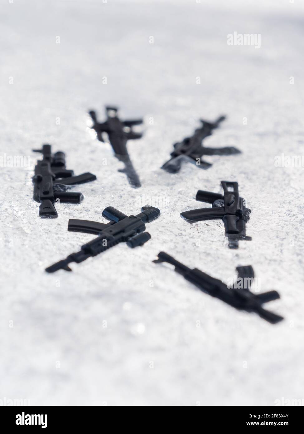 Toy guns on ice Stock Photo - Alamy