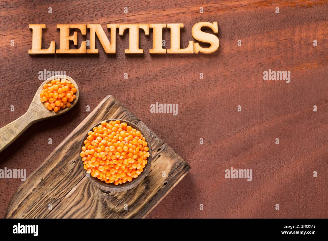 Raw lentils in the bowl - Lens culinaris. Wooden background Stock Photo ...