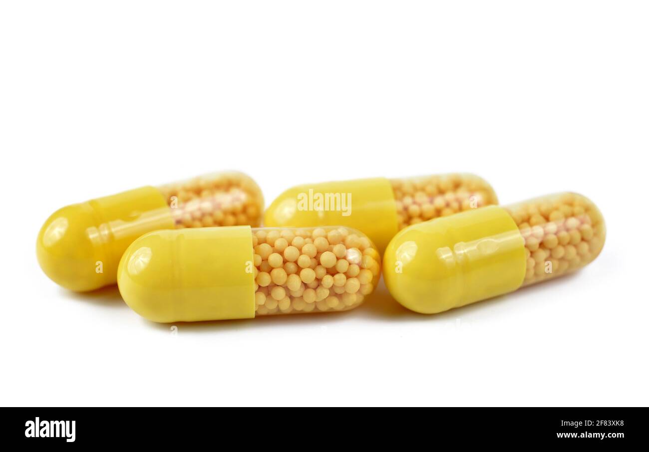 Yellow capsule pills isolated on white background. Pharmaceutical ...