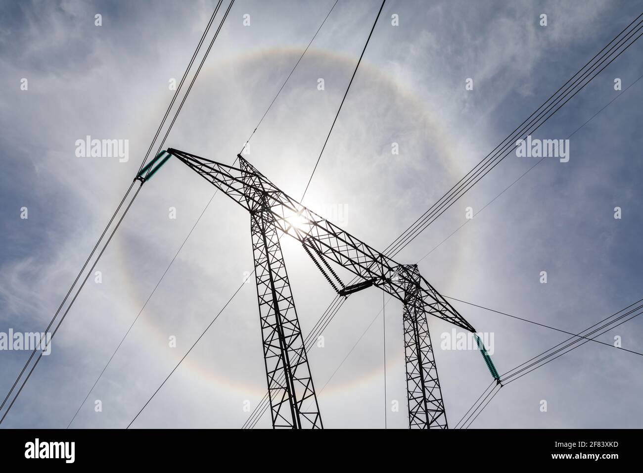 sun light through an electric pylon creates a round flare Stock Photo ...