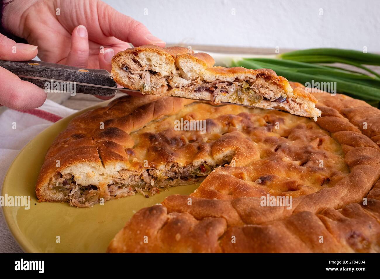 Close up of a slice of calzone - Traditional stuffed pizza of Puglia ...