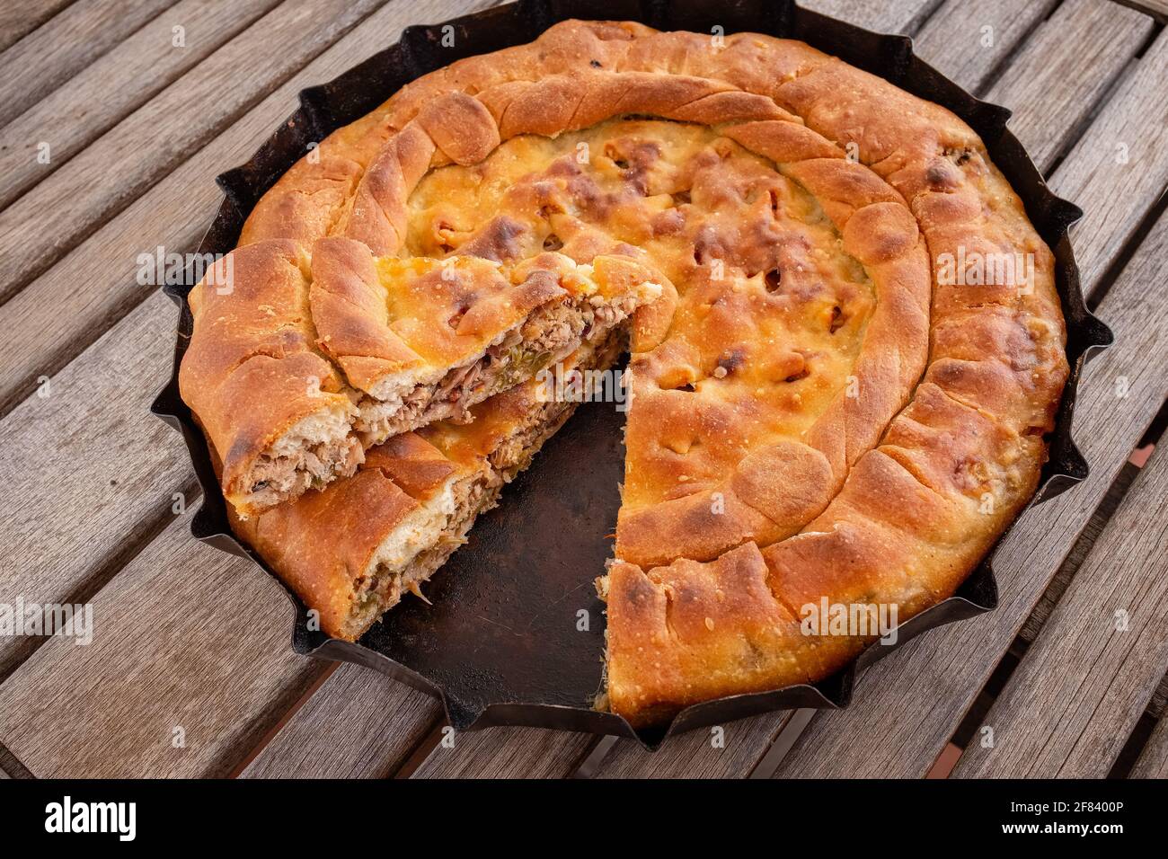 Calzone filled with onion and tuna - Traditional stuffed pizza of ...