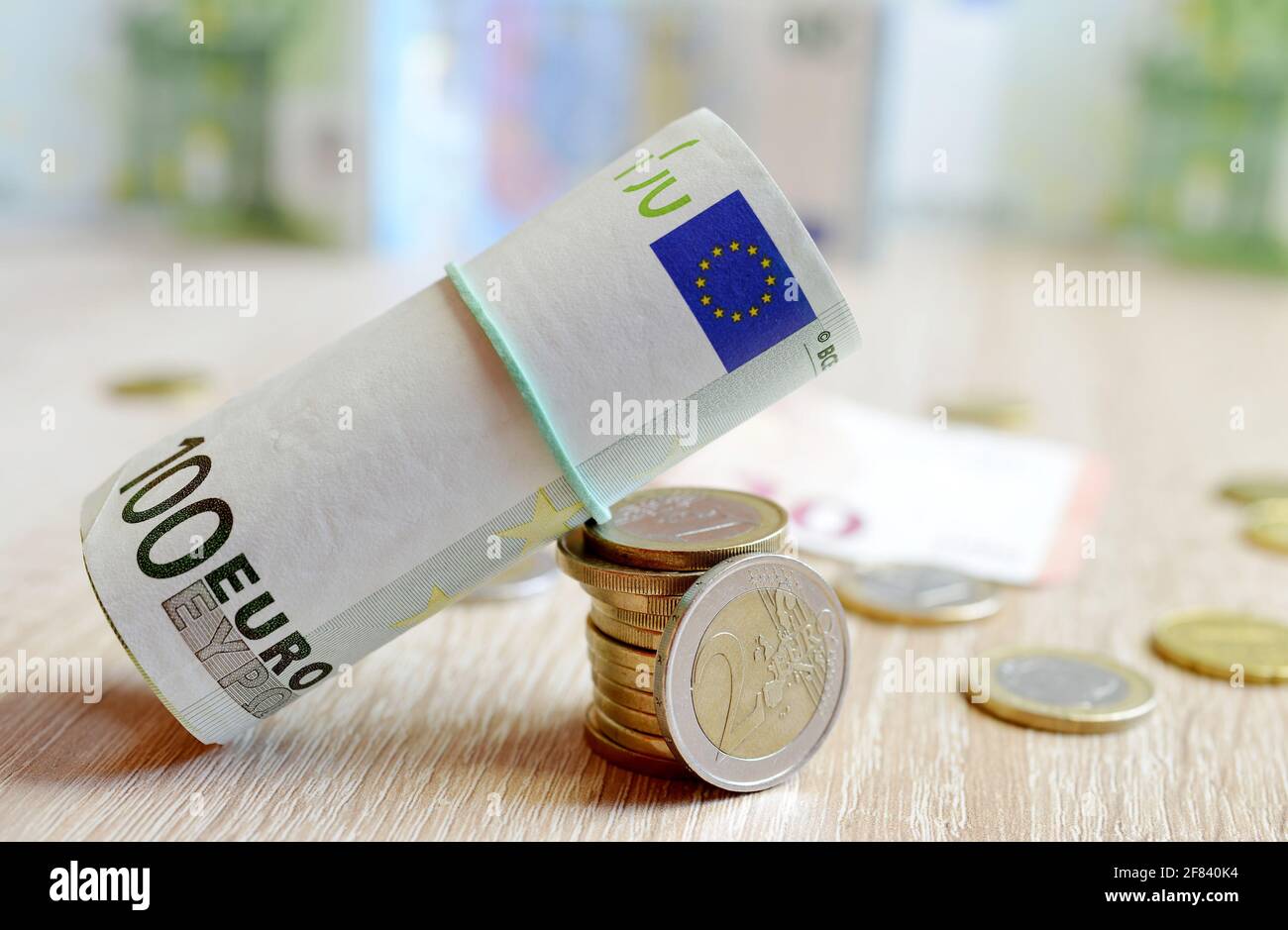 Euro coins and banknote on wooden board Stock Photo - Alamy