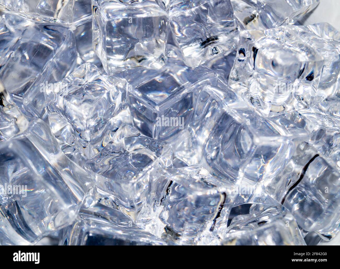 diffuse light shines on a handful of ice cubes Stock Photo - Alamy