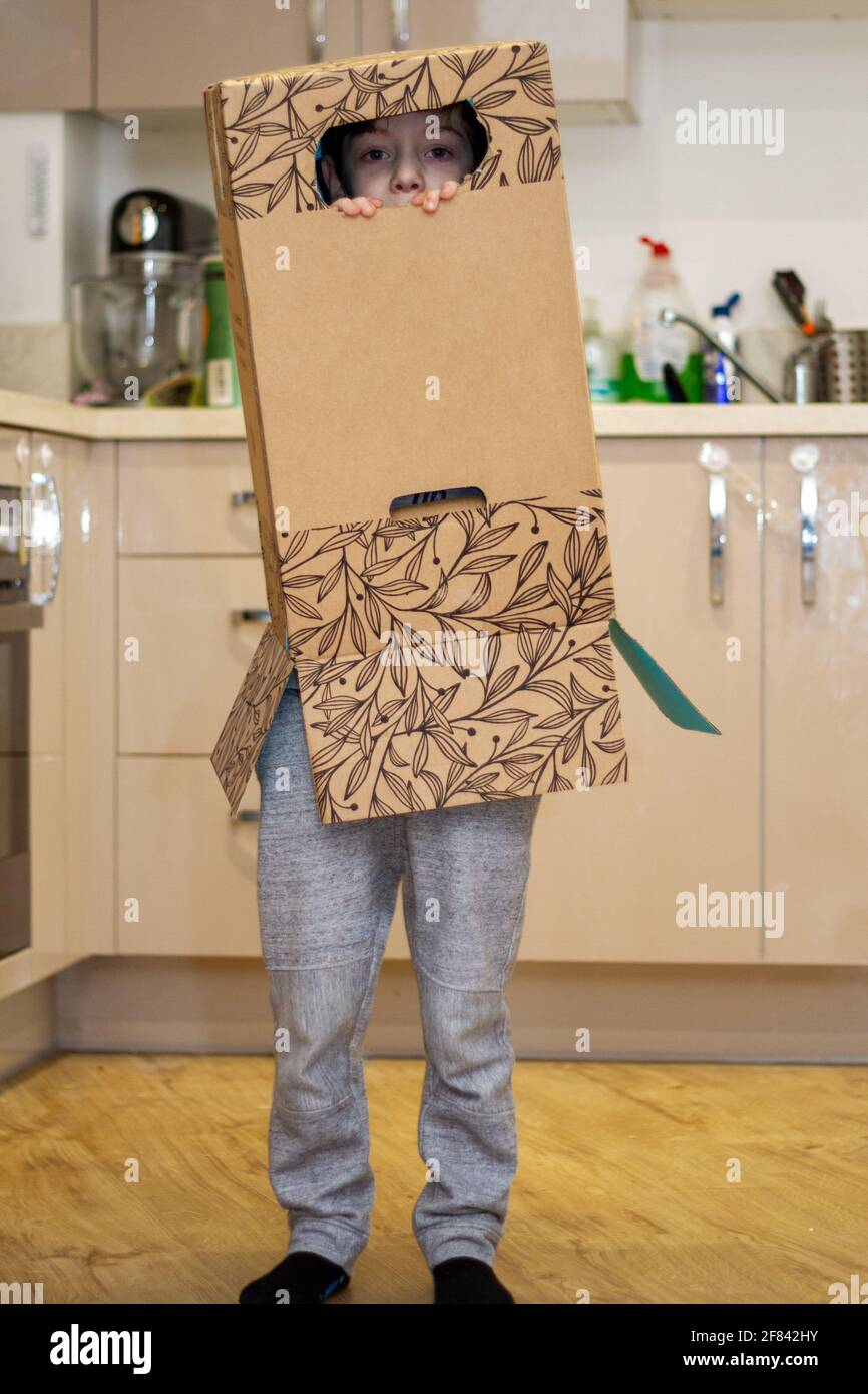 Boy hiding inside cardboard box hi-res stock photography and images - Alamy