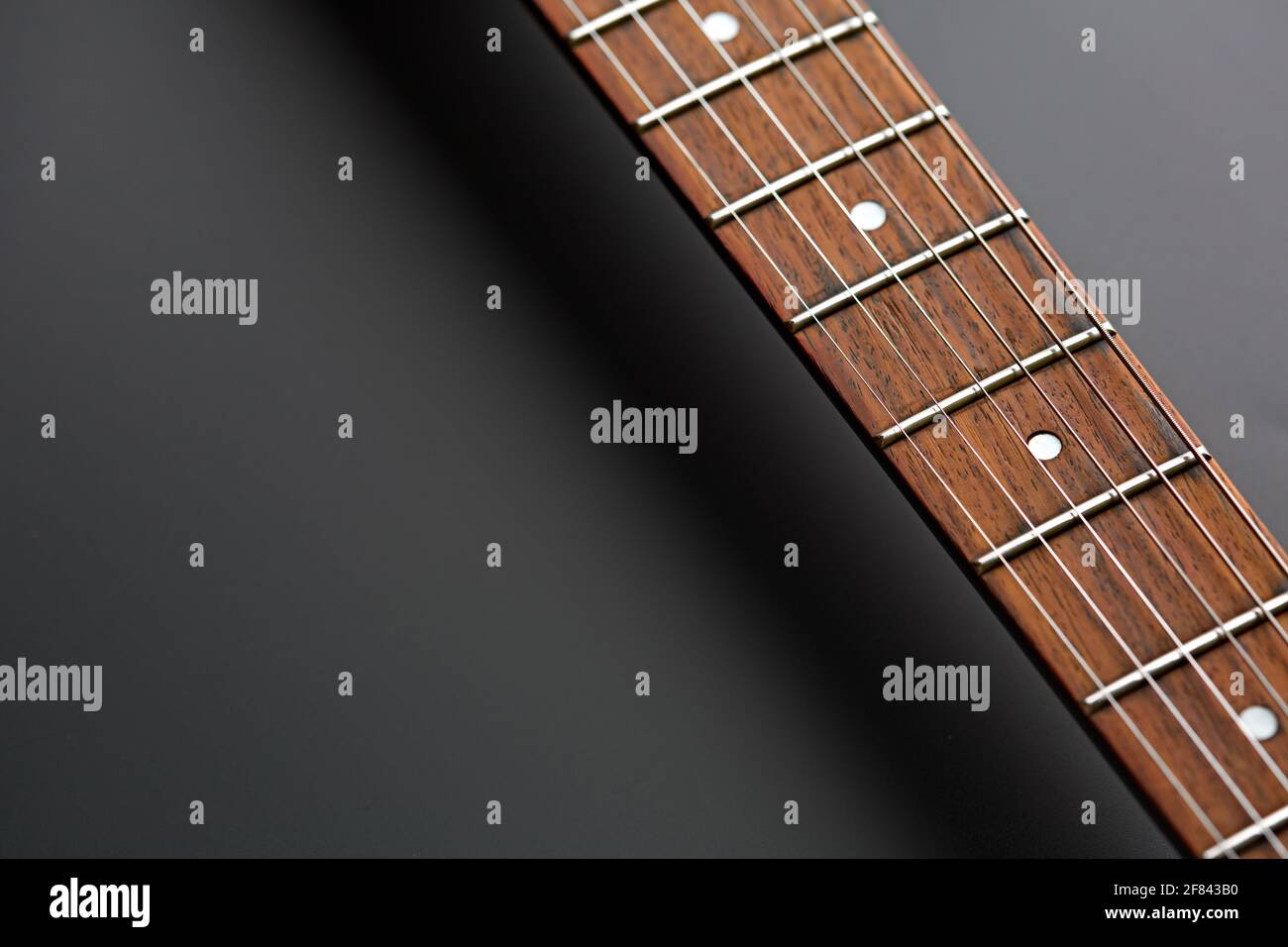 Electric guitar, closeup view on wooden fretboard Stock Photo - Alamy