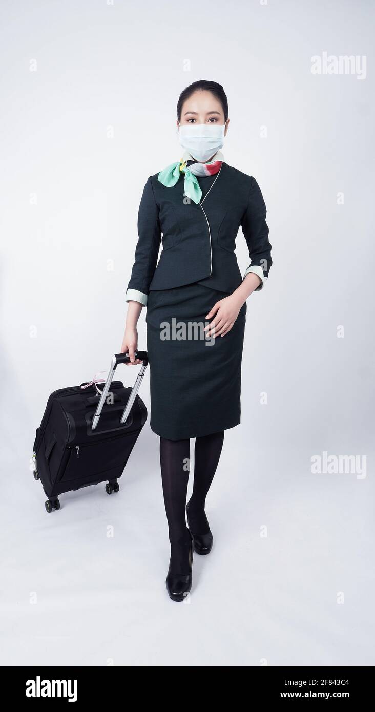 Cabin crew or air hostess with face mask in Covid 19 pandemic. Flight ...