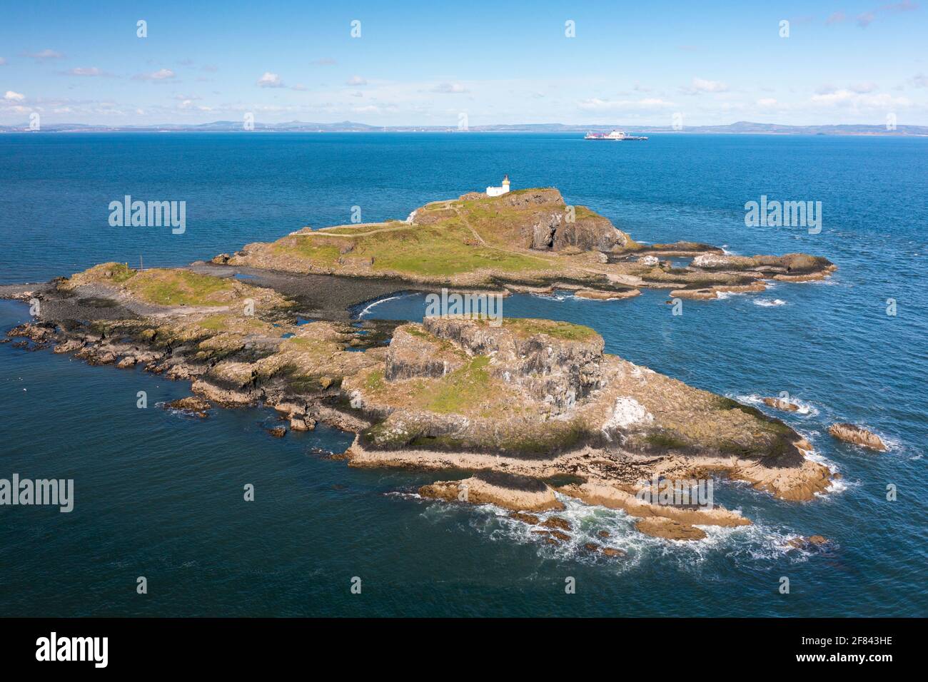 Aerial view from drone of Fidra Island and lighthouse in Firth of Forth ...