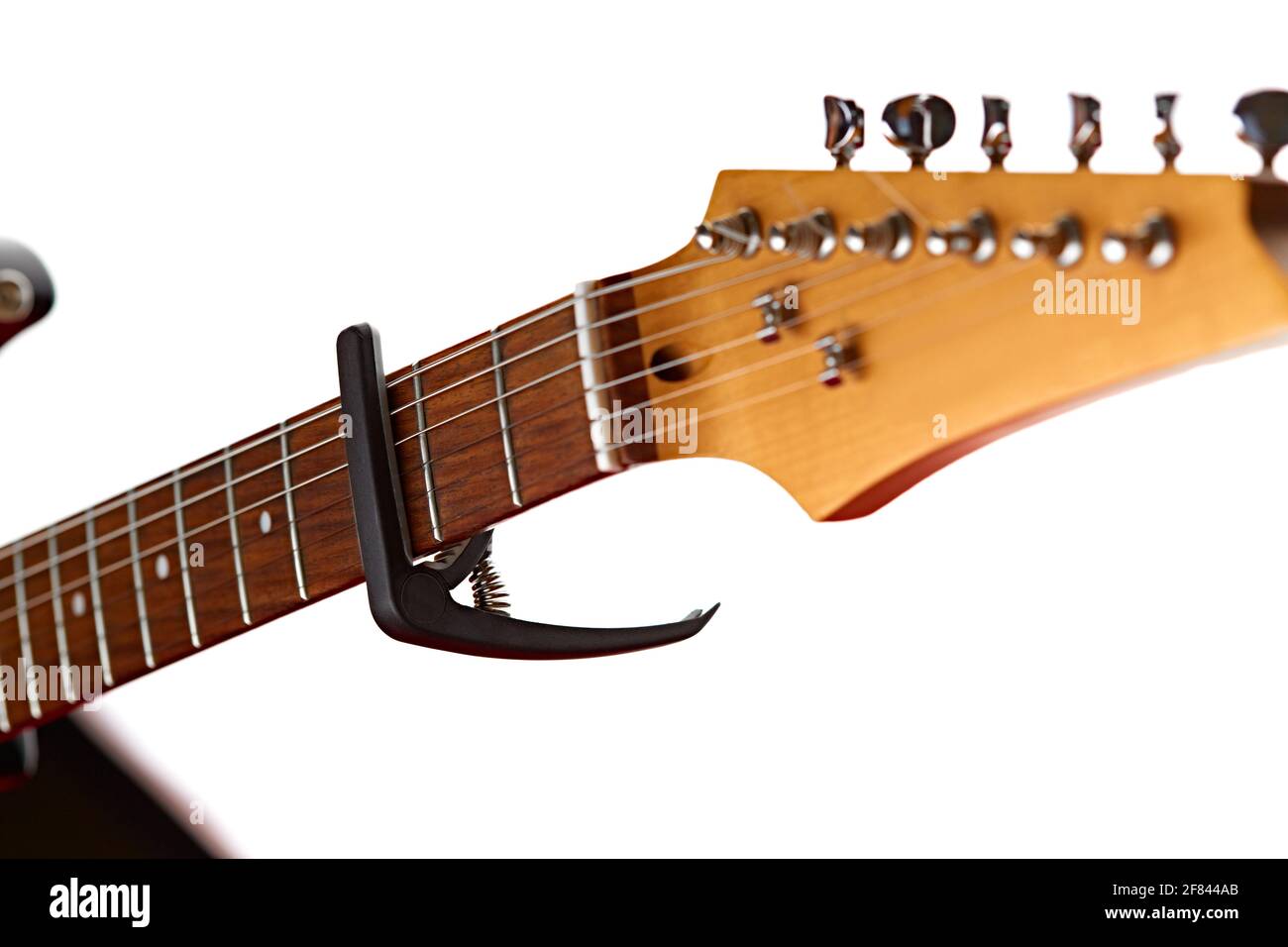 Electric guitar fretboard with capodaster, closeup Stock Photo - Alamy