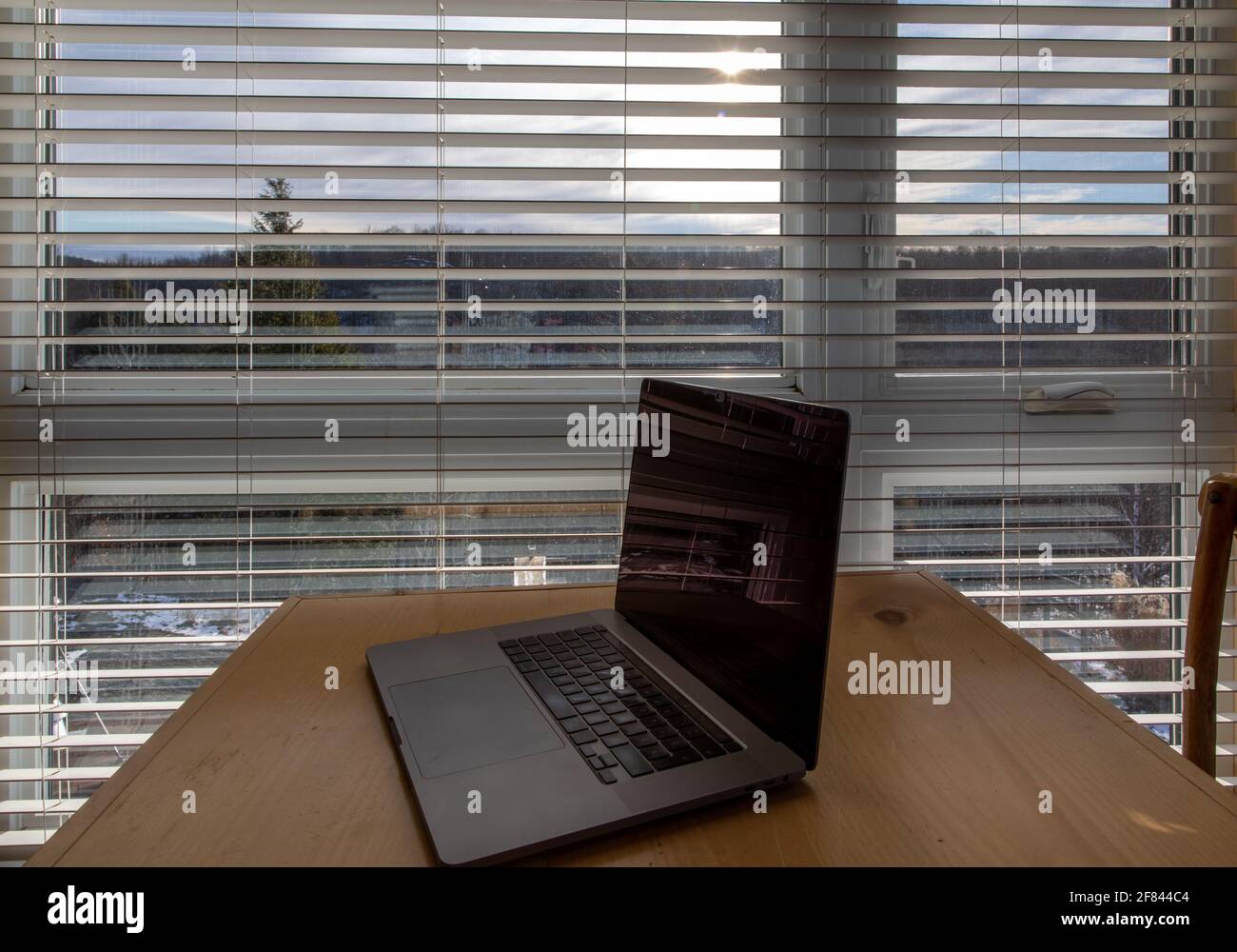 side view of a table top on the side of a window with blinds Stock ...
