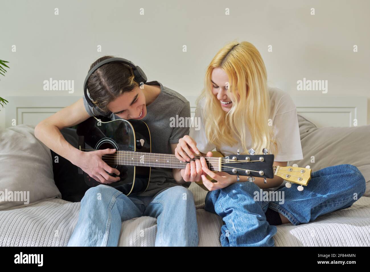 Creative teenagers friends with musical instruments, acoustic guitar ...