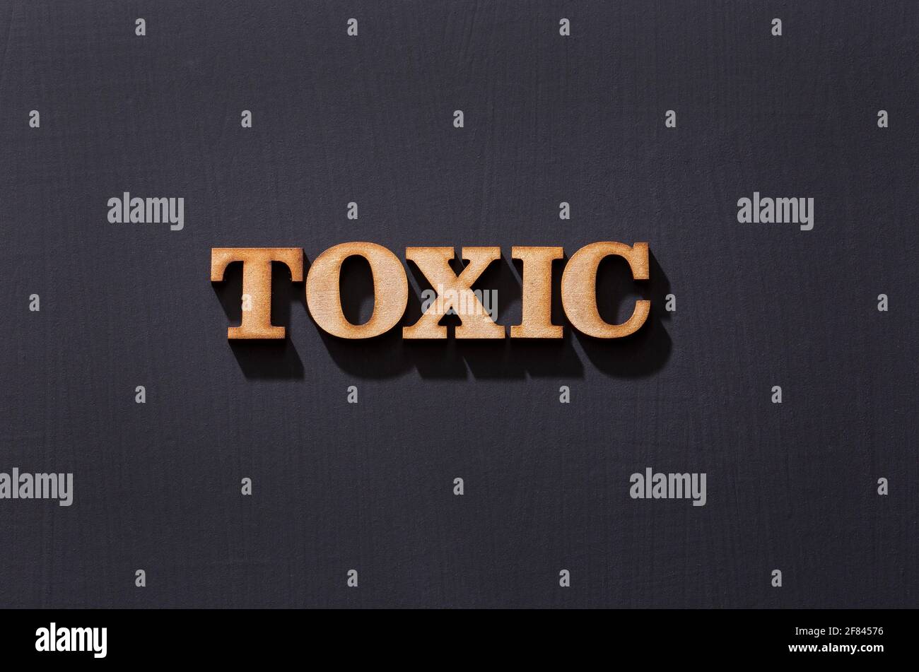 Toxic word in wooden letters - Black background Stock Photo - Alamy