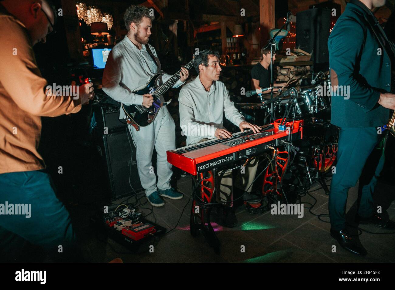 band performing at a party musician playing a red synthesizer Stock ...