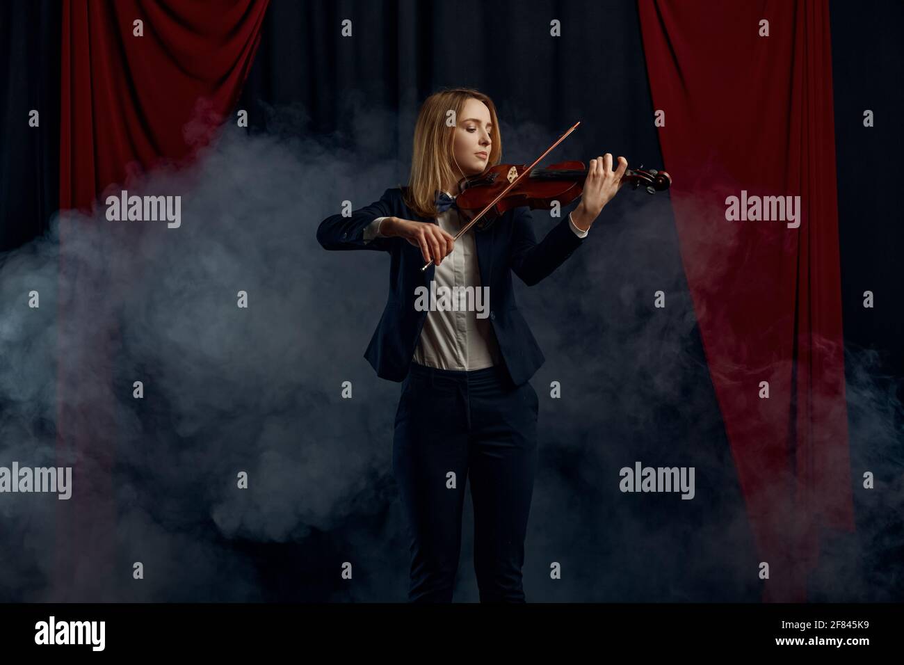 Female violonist with violin, performance on stage Stock Photo - Alamy