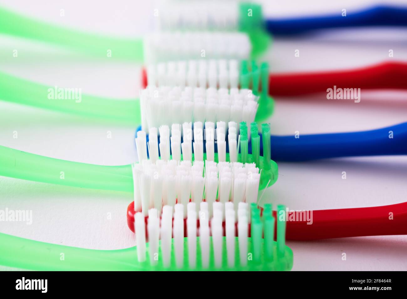 A shot of toothbrushes in a row isolated on white background Stock ...