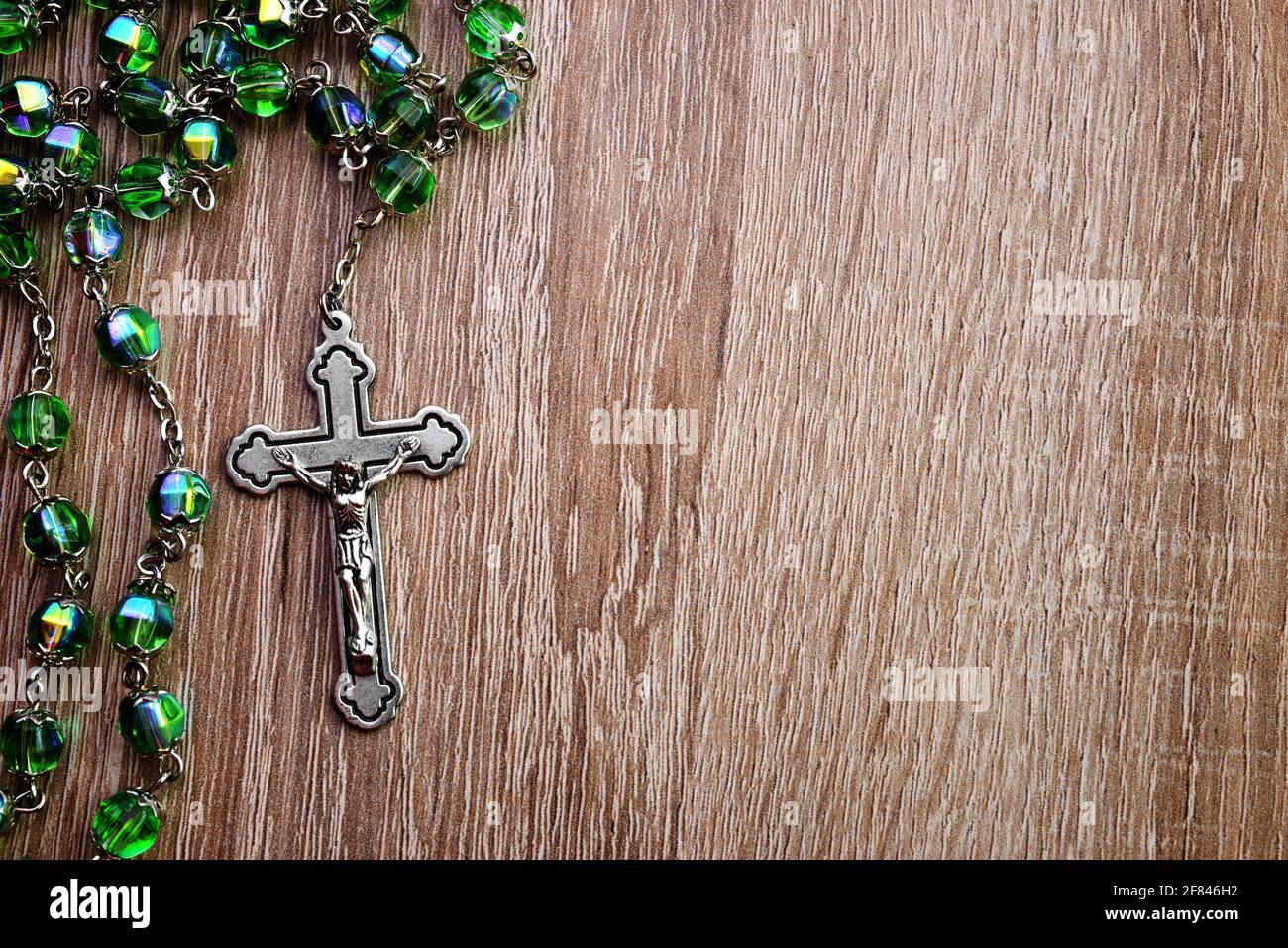Christian rosary on a wooden texture background Stock Photo - Alamy