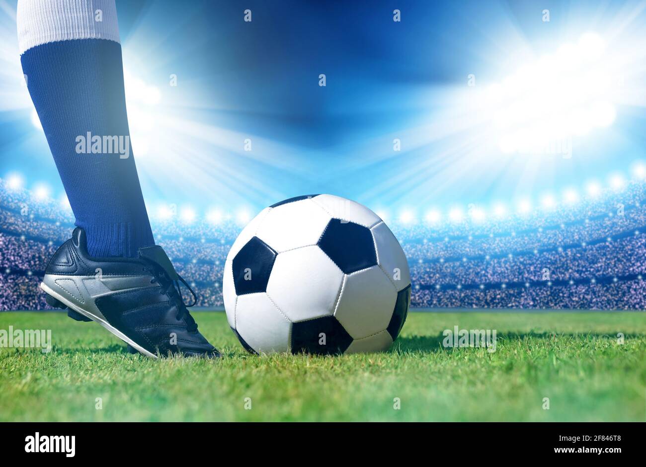 Soccer ball with feet player on the football field in stadium Stock ...