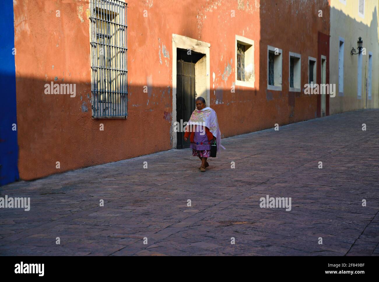 Indigenous Nahua woman wearing a traditional huipil walking on the ...