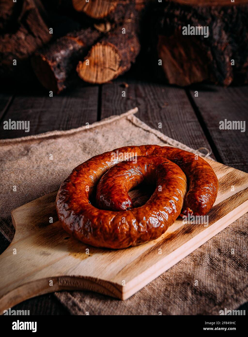 Sausage in wood rustic table Stock Photo - Alamy
