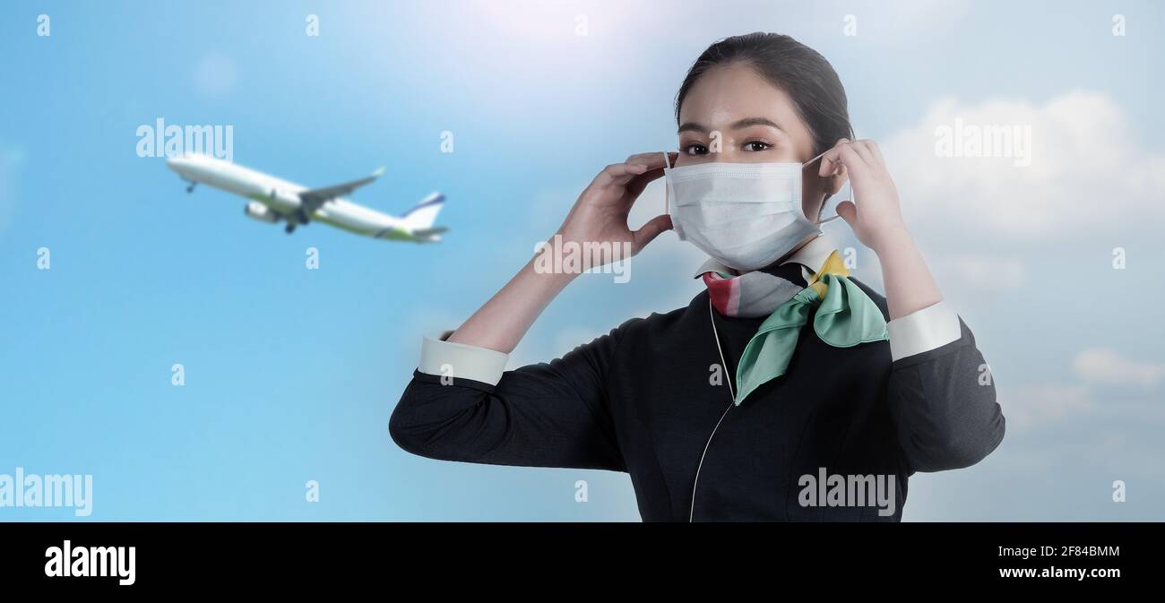 Cabin crew or air hostess with face mask in Covid 19 pandemic. Flight ...