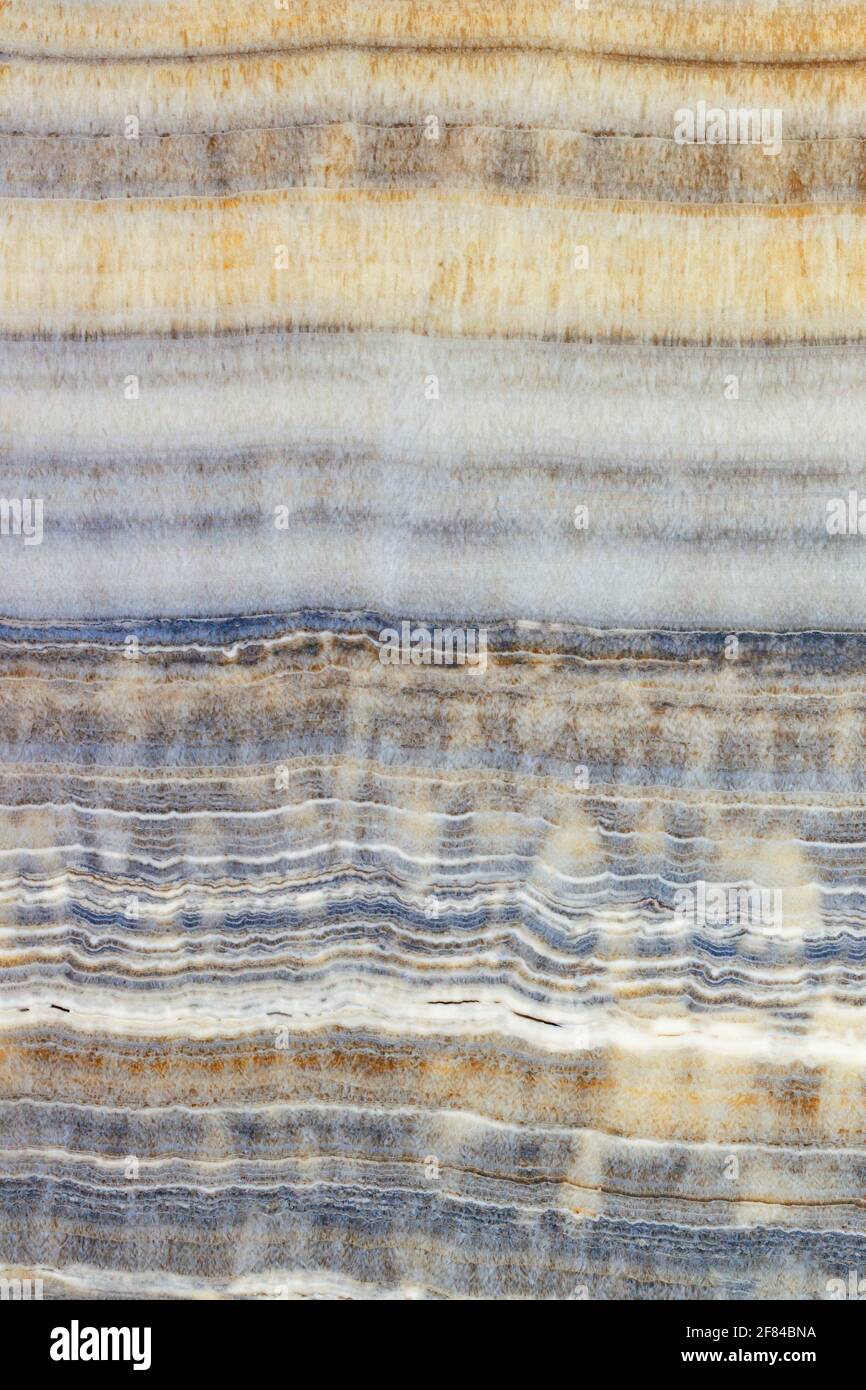 Beige marble texture with wavy gray, brown and blue horizontal stripes ...
