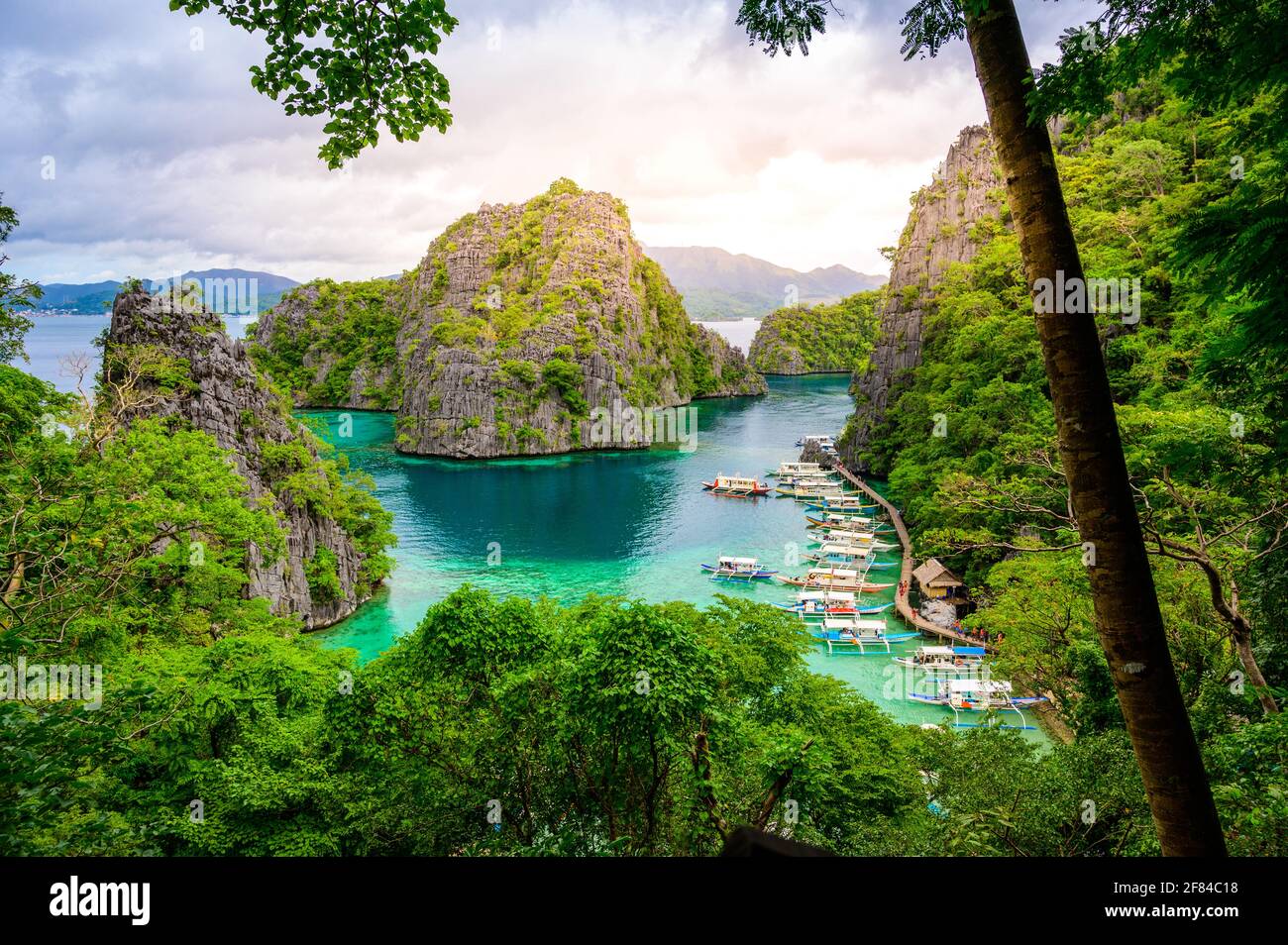 Blue crystal water in paradise Bay with boats on the wooden pier at ...