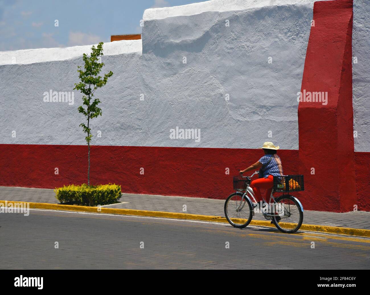 Local female inhabitant riding her bicycle on the streets of Cholula in ...