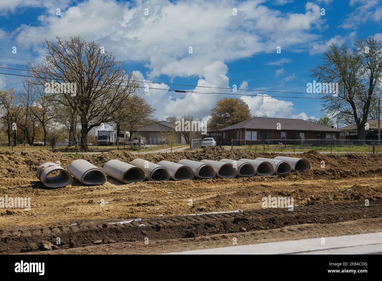 Stacks of concrete sewage pipes on the ground prepare for underground ...