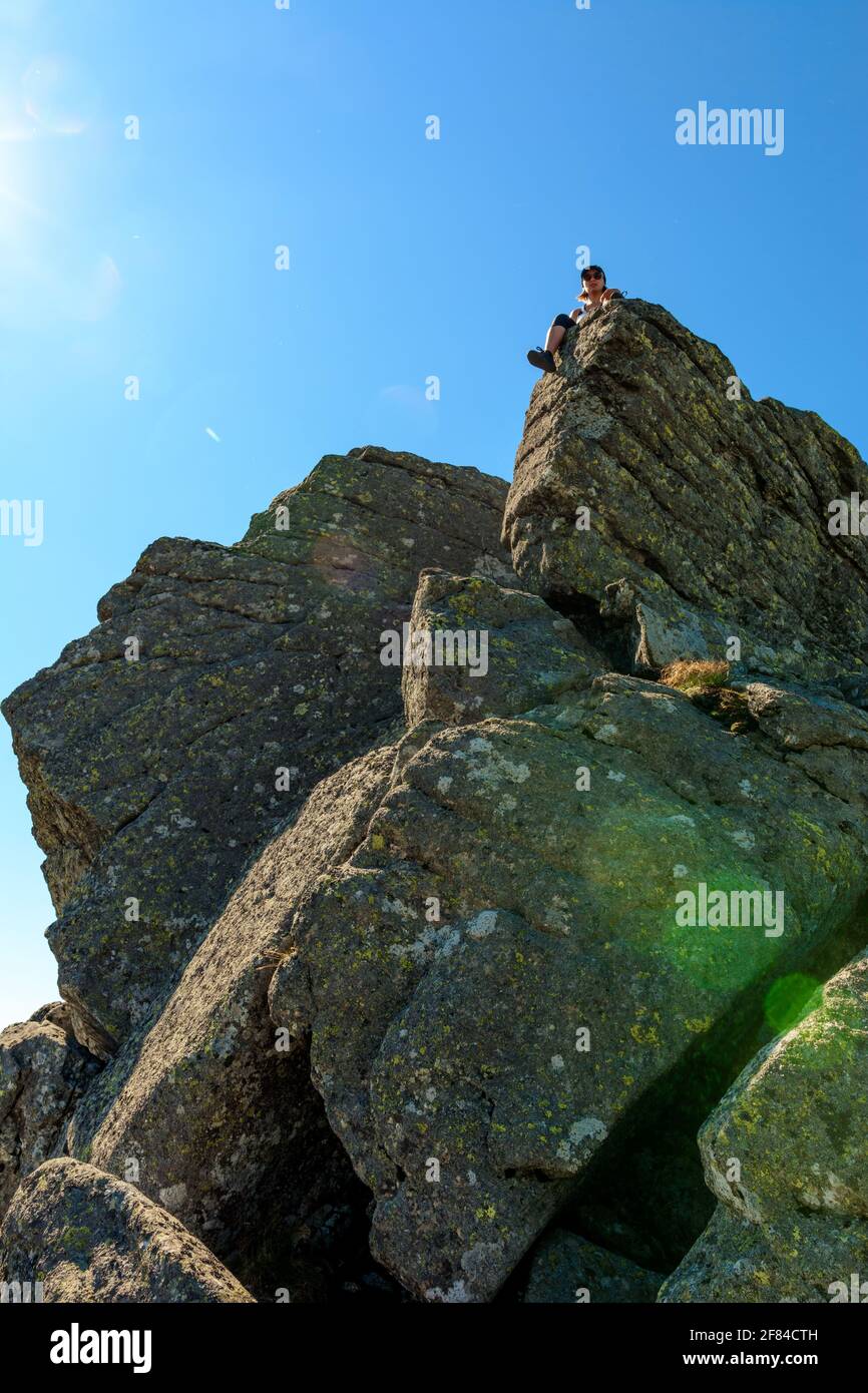 A tourist on top of a large stone block, the top of Smotrych mountain ...