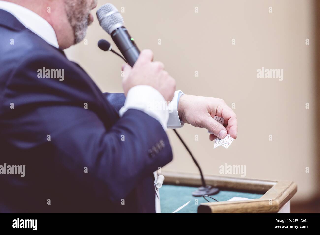 A man talking on the microphone on stage - public speech Stock Photo ...