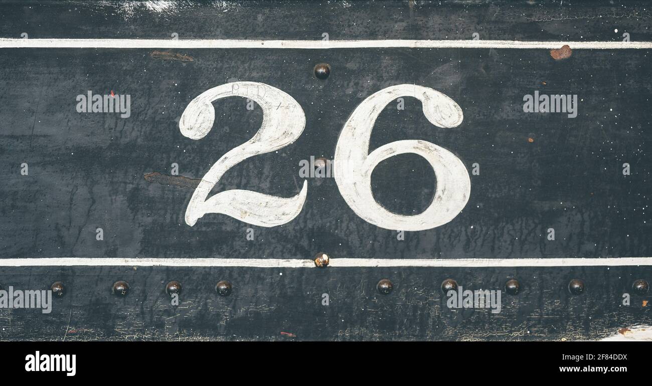 The number 26 on a dark metallic surface Stock Photo - Alamy