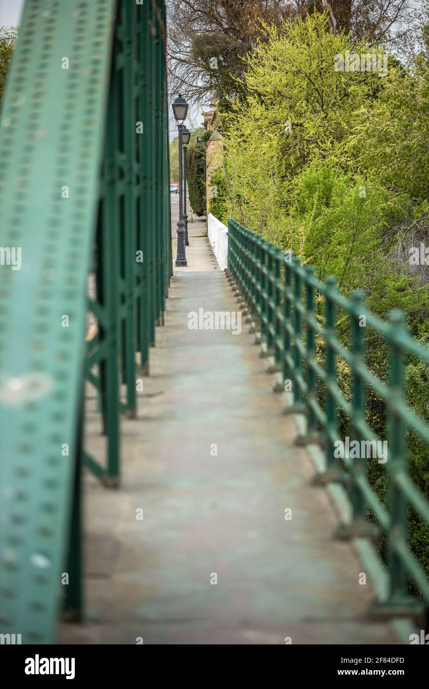 A pedestrian pathway on a green metallic bridge Stock Photo - Alamy