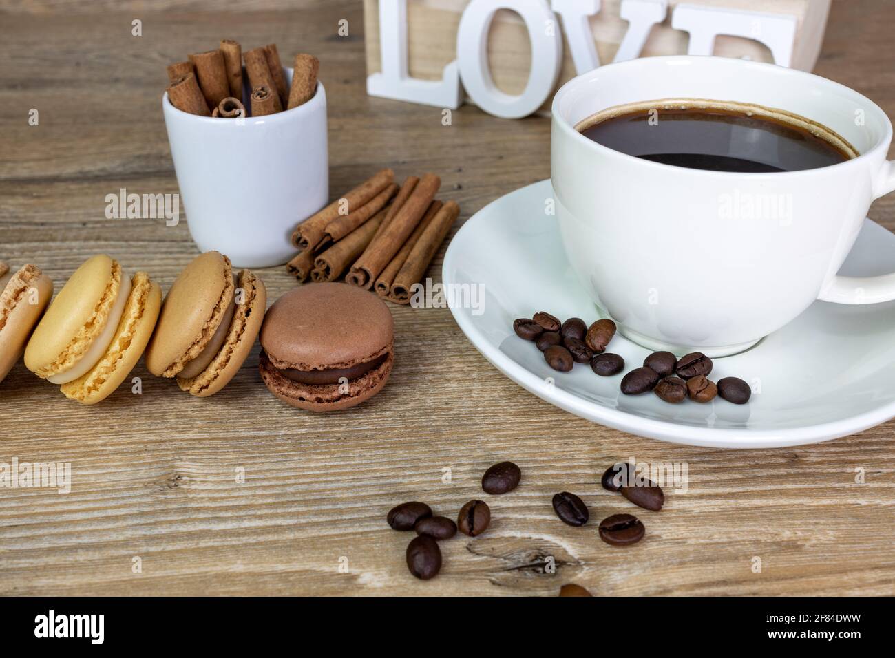 coffee break with cup of espresso and colorful macarons of chocolate ...