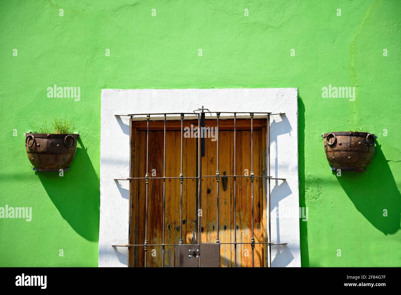 Colonial house window with handcrafted iron grilles, white trim and ...