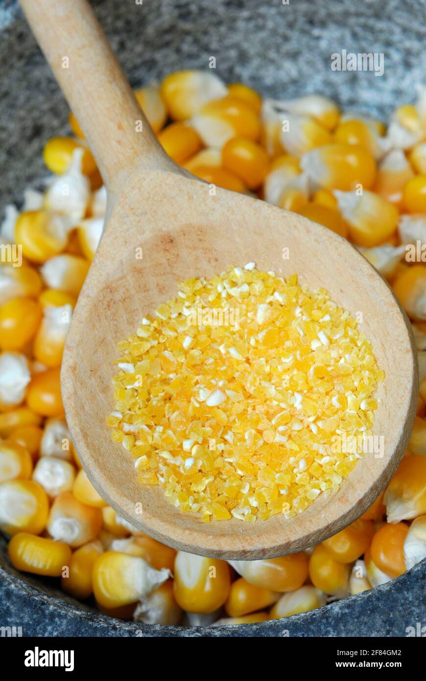Polenta, Corn (Zea mays) semolina, flour, grains, wooden spoon Stock ...