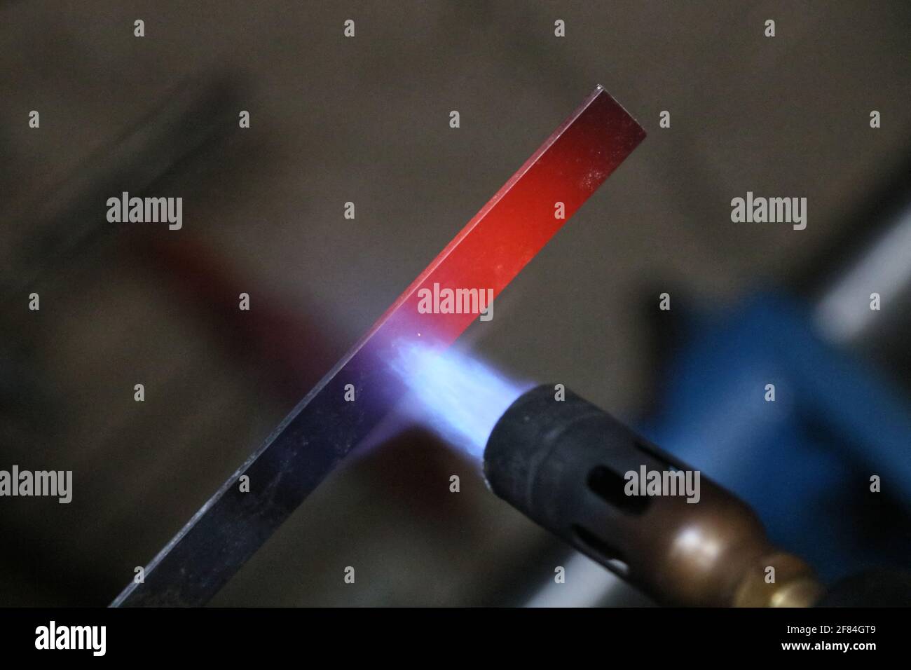 heating up a piece of steel to glow Stock Photo - Alamy