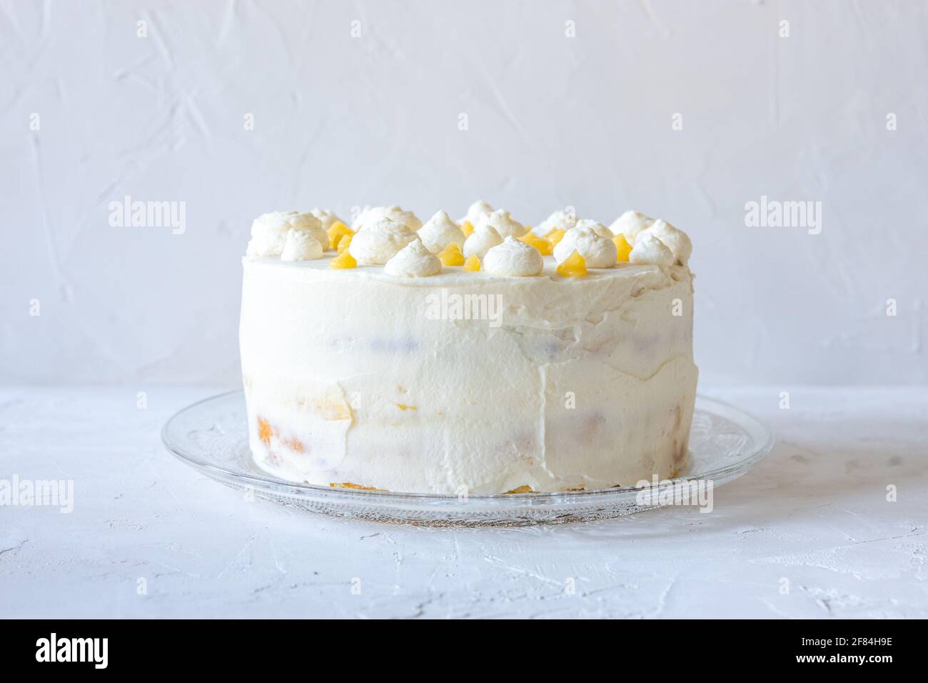 Lemon Victoria Sponge Cake decorated with dots of mascarpone cream and ...