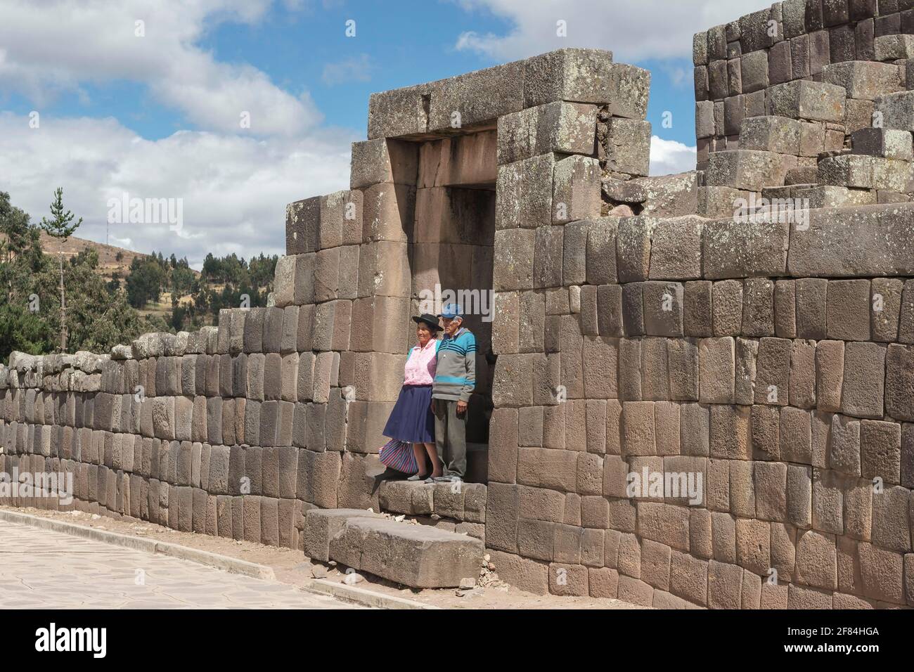 Old indigenous couple posing in the gate of the pyramid of the Incas ...