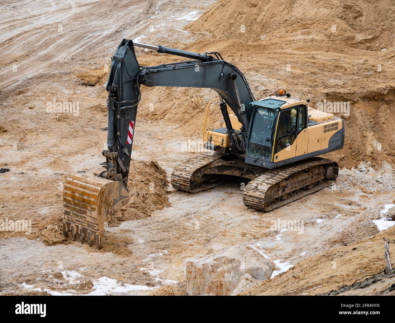 Track type loader excavator in large white sand quarry. Excavator ...