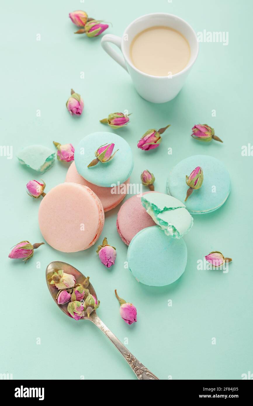 Coffee cup and colorful macaron on pastel background top view. Cozy ...