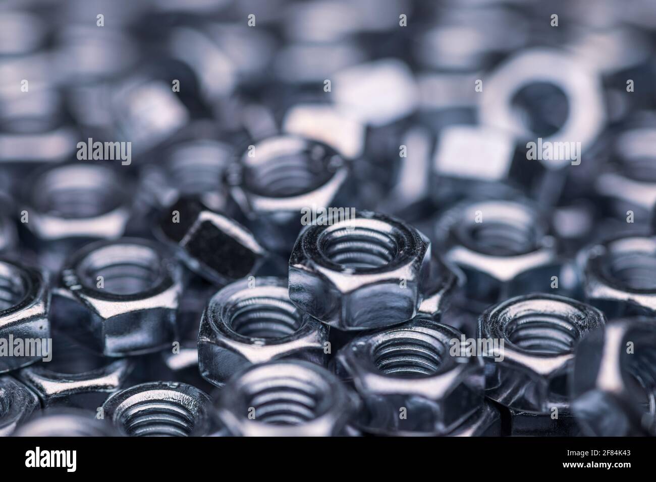 Metal chrome nuts in a chaotic order industrial background Stock Photo ...